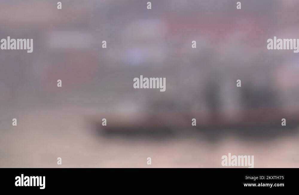 Rack focus to riverboats crossing on the Ganges River in Varanasi ...