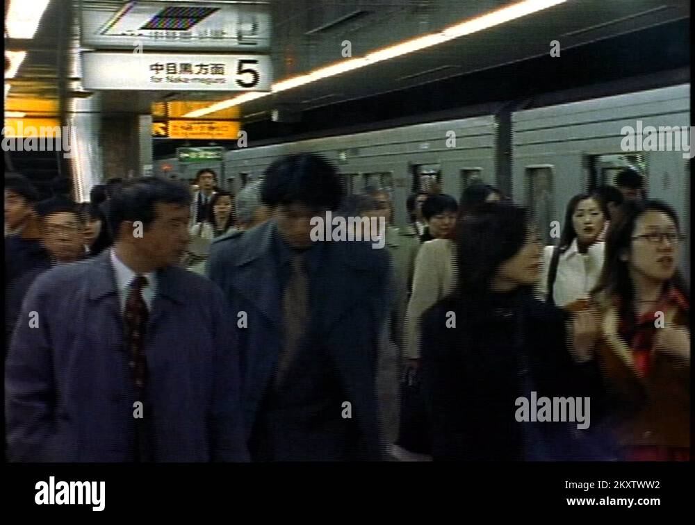 The Tokyo Subway, crowd on platform, wide shot, train, zoom in, doors ...