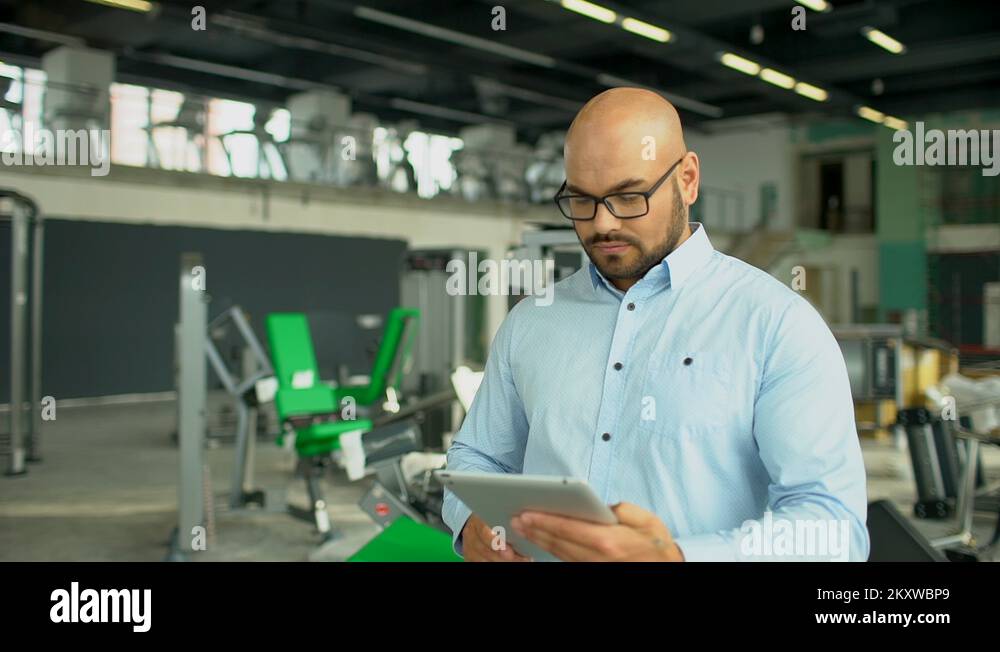 the owner of a sports club. portrait jf the owner gym. many simulators ...