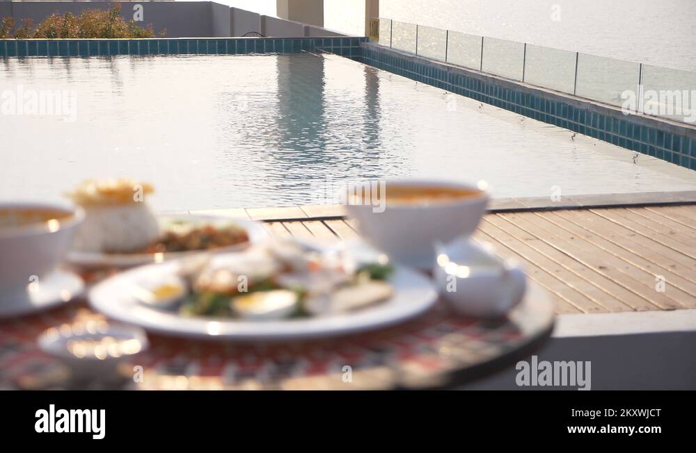 dishes of Thai cuisine. 4k. table by the pool. Thai traditional lunch ...