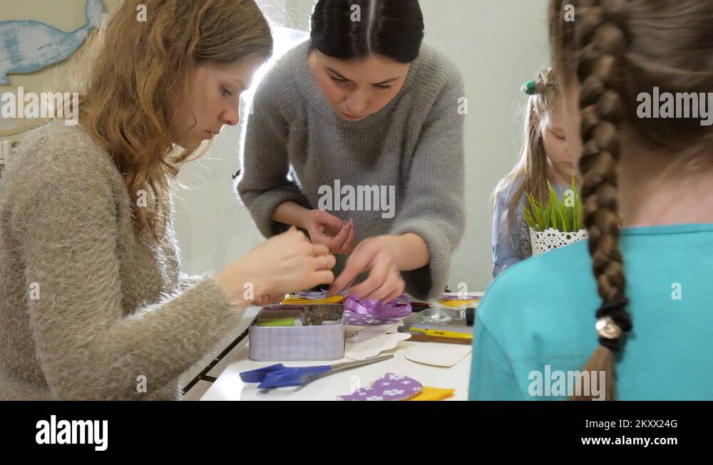 Girls at the lesson with the teacher sew a soft toy with their own ...