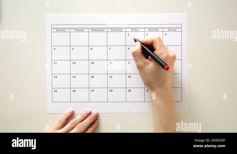 Sign the day in the calendar with a pen, draw a smile Stock Video ...