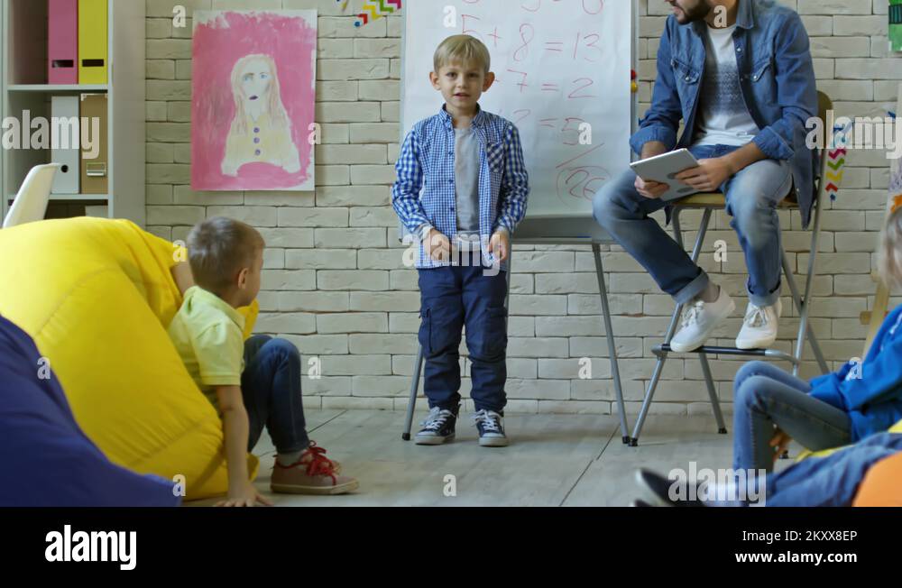 Cute Boy Speaking in Front of Classmates in Kindergarten Stock Video ...