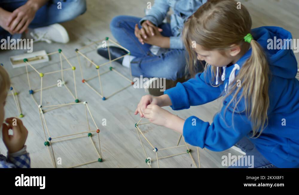 Girls Making 3D Shape with Craft Sticks at Kindergarten Lesson Stock ...