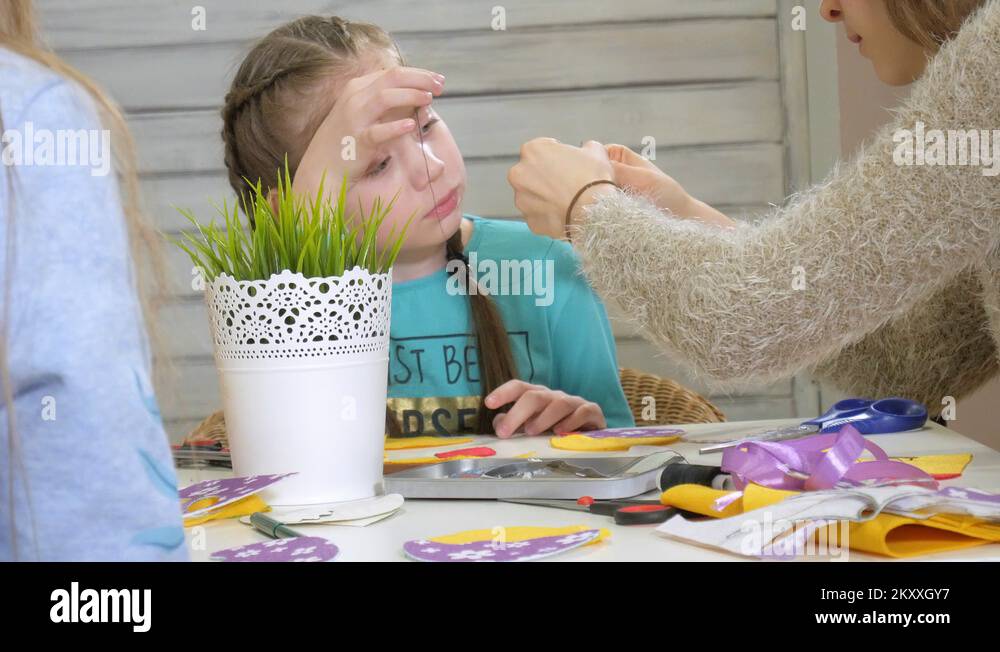 Girls at the lesson with the teacher sew a soft toy with their own ...