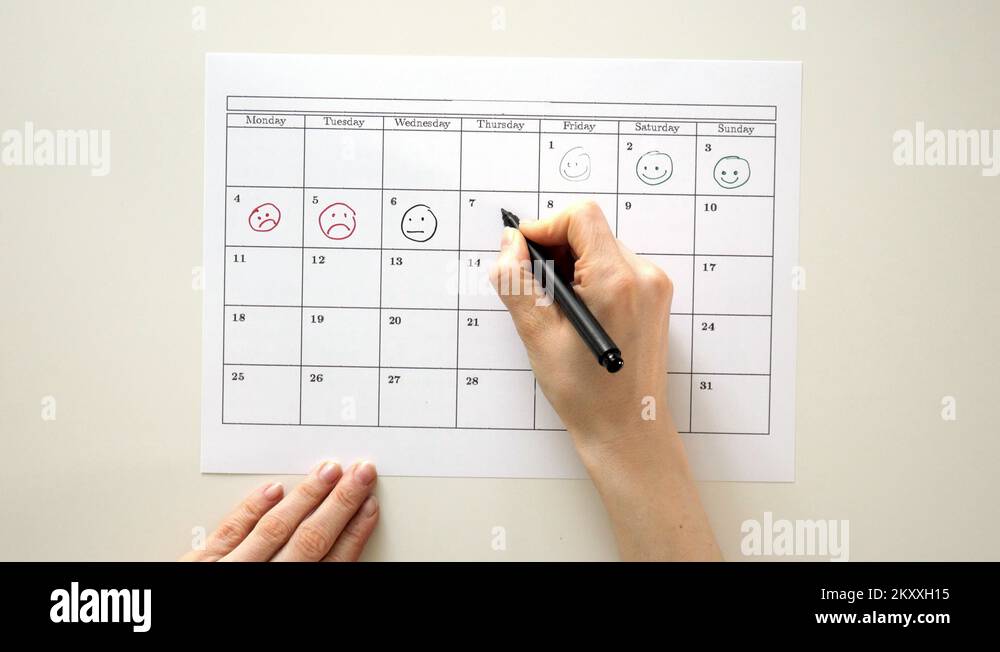 Sign the day in the calendar with a pen, draw a smile Stock Video ...