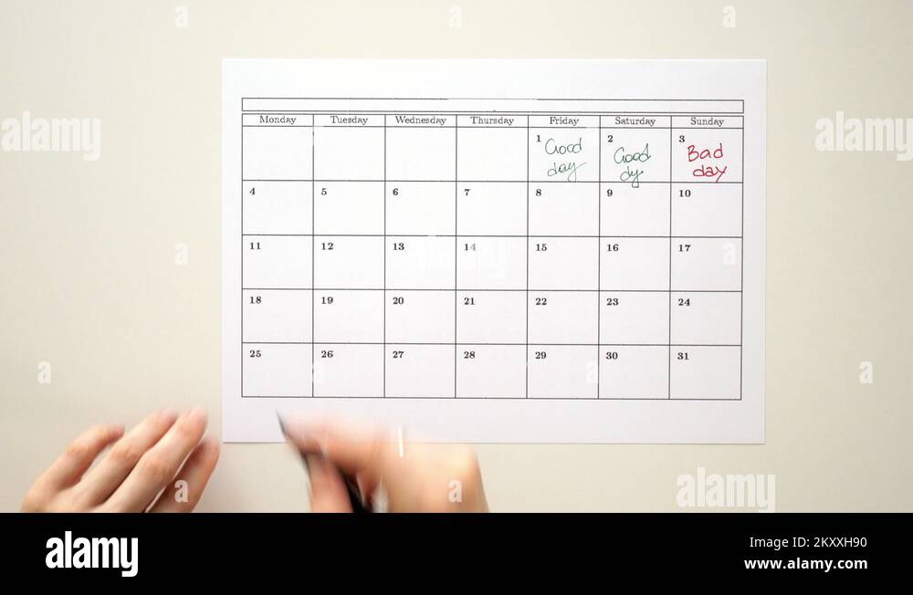 Sign the day in the calendar with a pen, draw a good bad day Stock ...