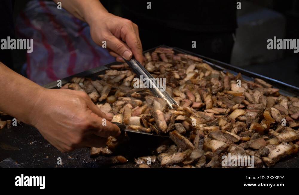 Slow Motion Vendor cooking Taiwanese pork meat on steel grill. Night ...