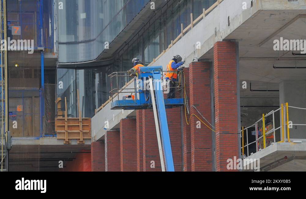 Highrise building construction workers making Stock Videos & Footage ...