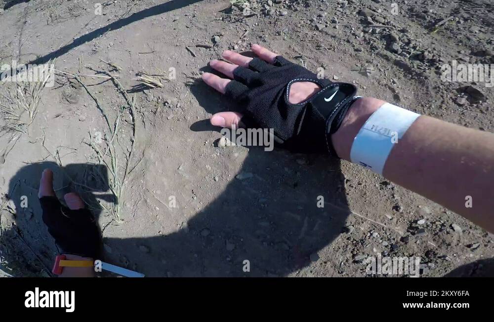 POV - a man crawls in mud under barbed wires at a race Stock Video ...