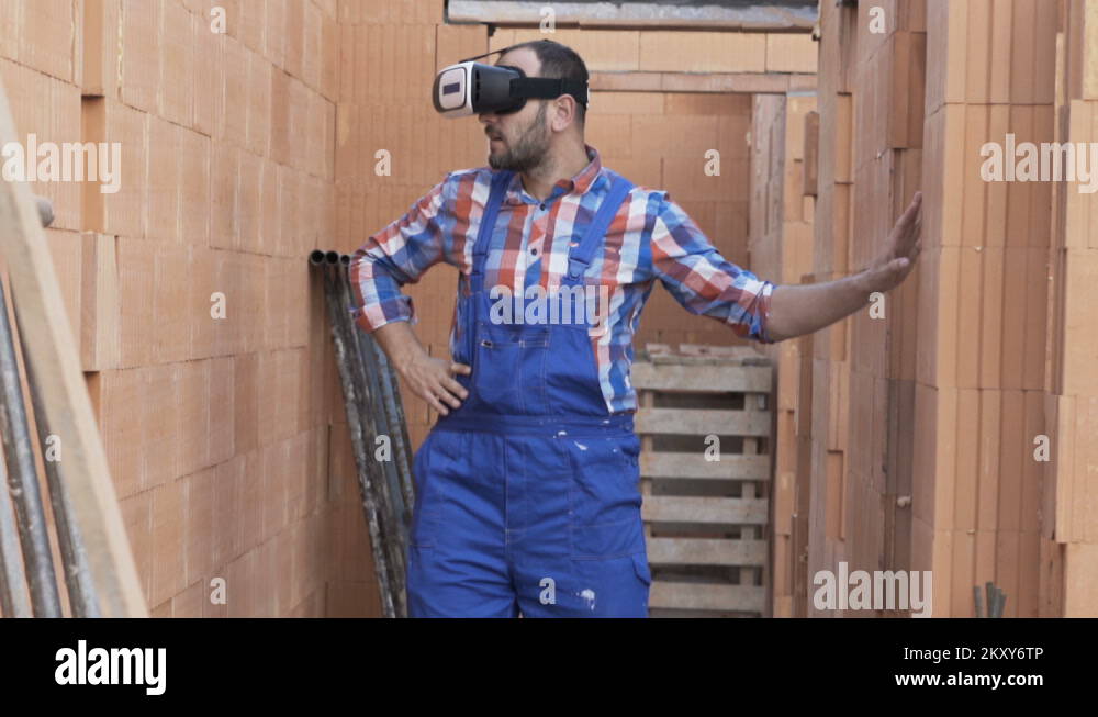 Man with vr goggle looking around new home at construction site Stock Video Footage - Alamy