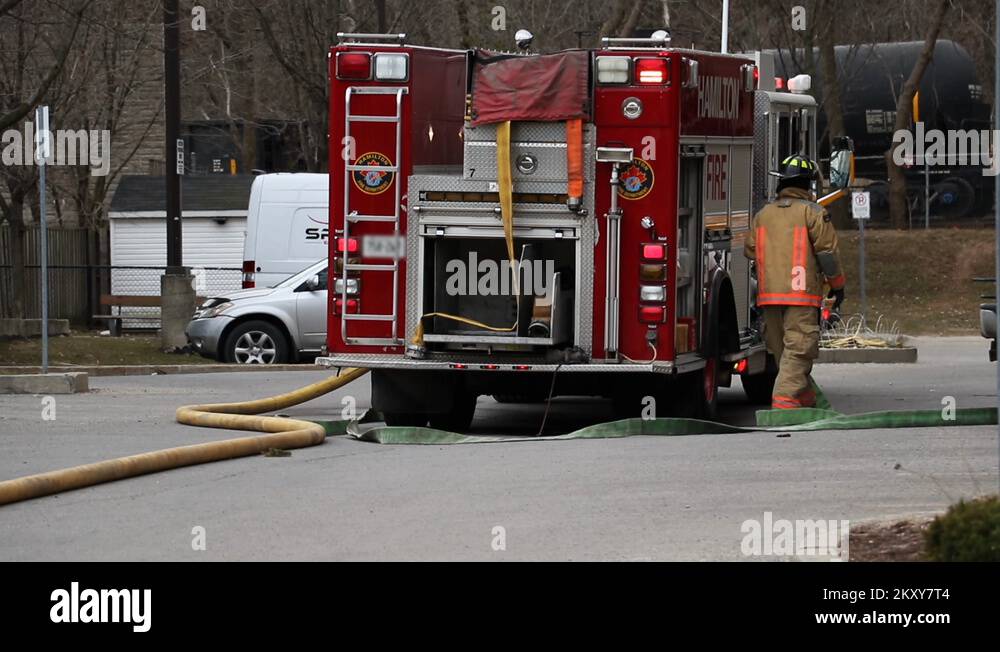 Fireman walking beside fire truck during a building fire. Emergency ...