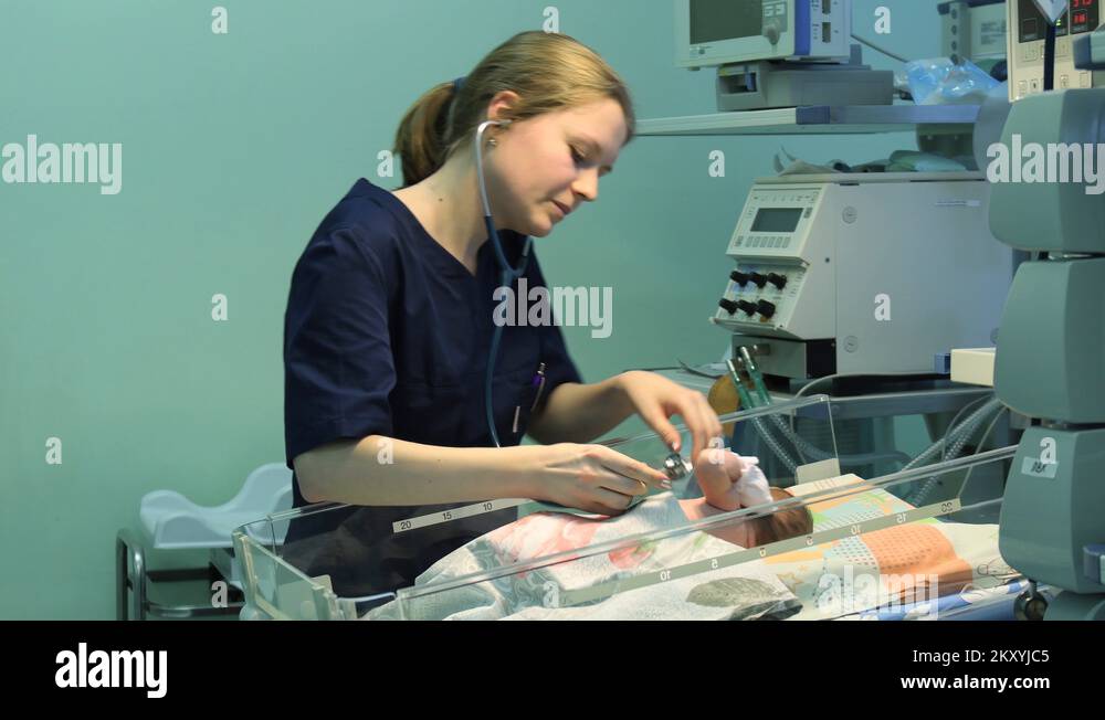 Neonatal Resuscitation. Female doctor examining newborn baby in clinic ...