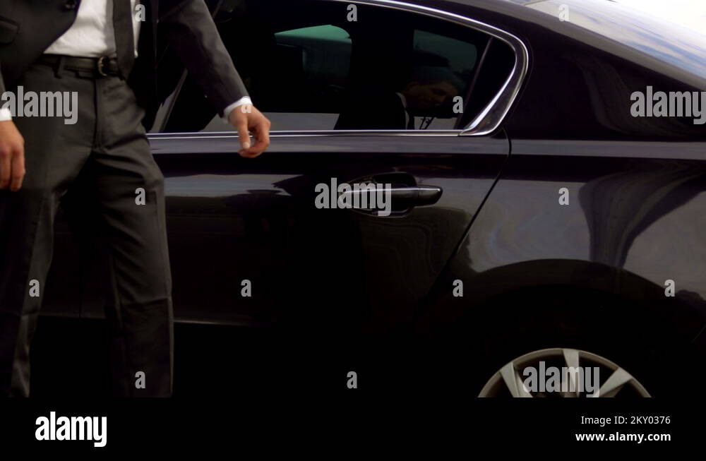Personal driver is opening the car door for his client Stock Video ...