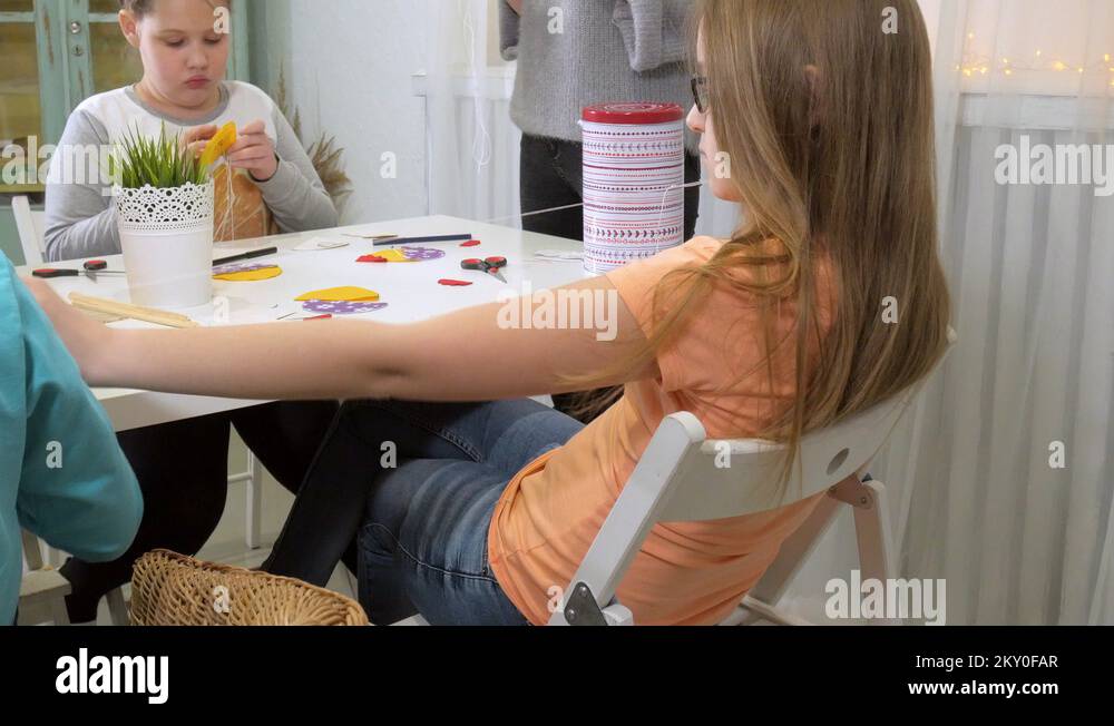 Girls at the lesson with the teacher sew a soft toy with their own ...