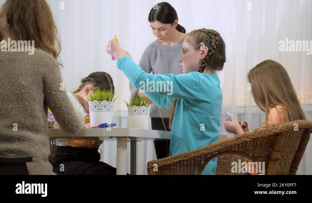 Girls at the lesson with the teacher sew a soft toy with their own ...