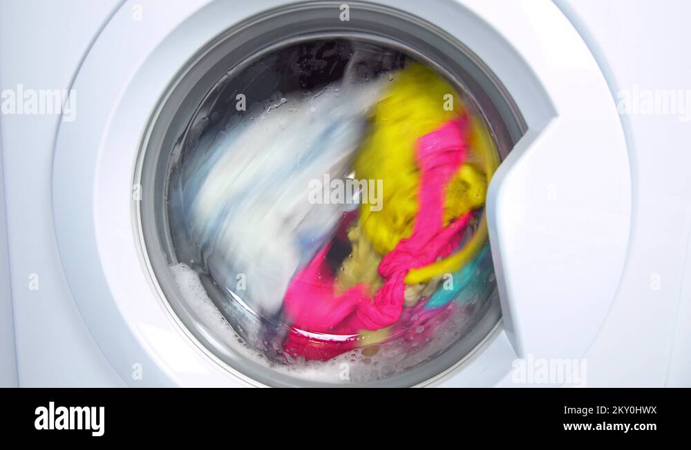 Washing machine washes colored clothing and sheets. Cylinder spinning ...