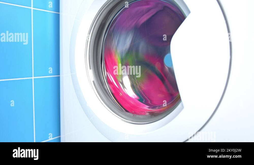 Washing machine washes colored clothing and sheets. Cylinder spinning ...