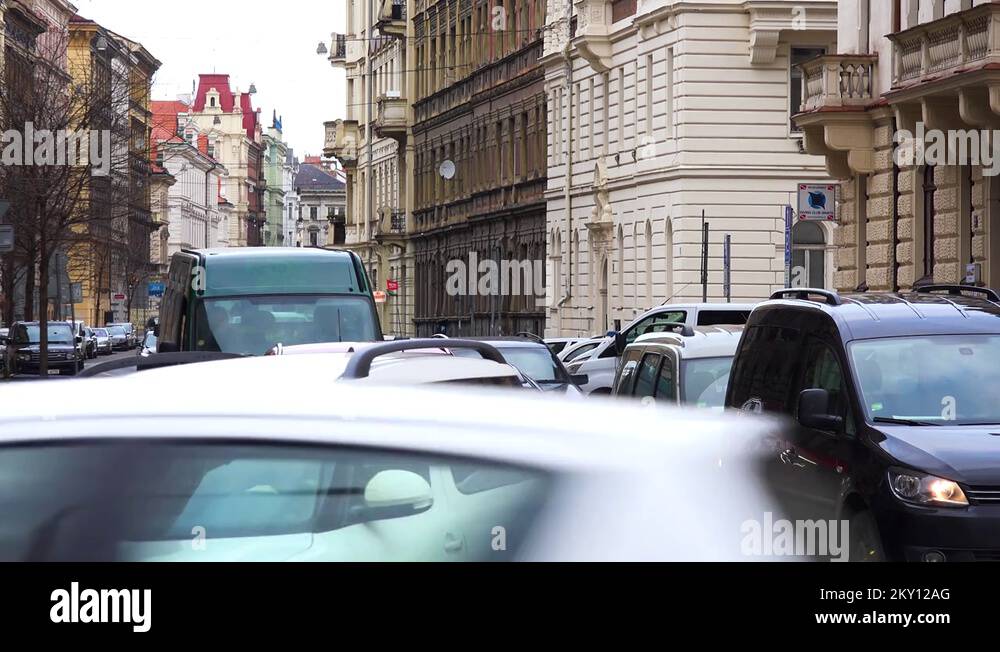 Cars wait in line in front of a crosswalk on a busy road in a Czech ...