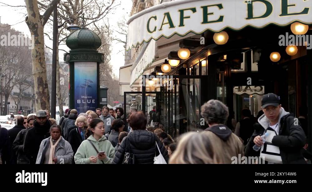 France Busy crowd of people walking public streets of Paris Cafe de ...