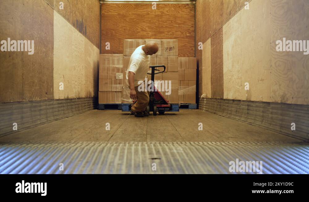 Man pulling stock on hand operated pallet truck Stock Video Footage - Alamy