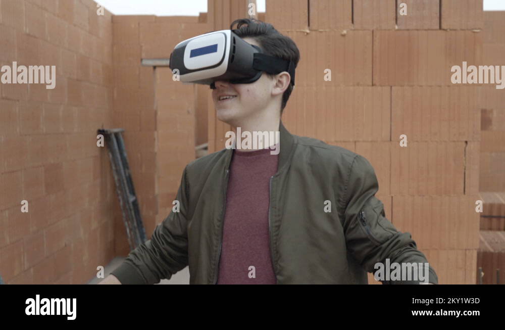 Teenage boy with vr goggle watching visual project of new home at ...