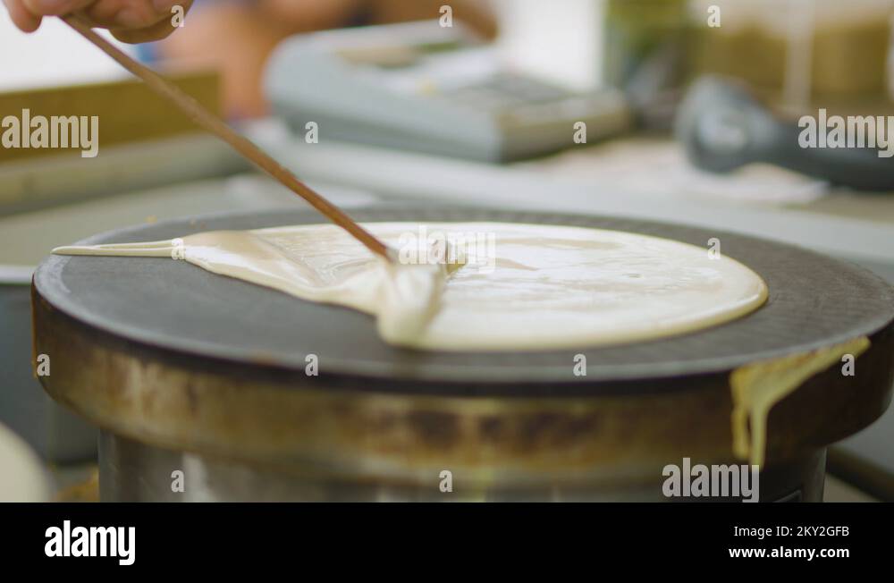 Step by step shots of making a french crepe with Nutella, fruits, ice ...