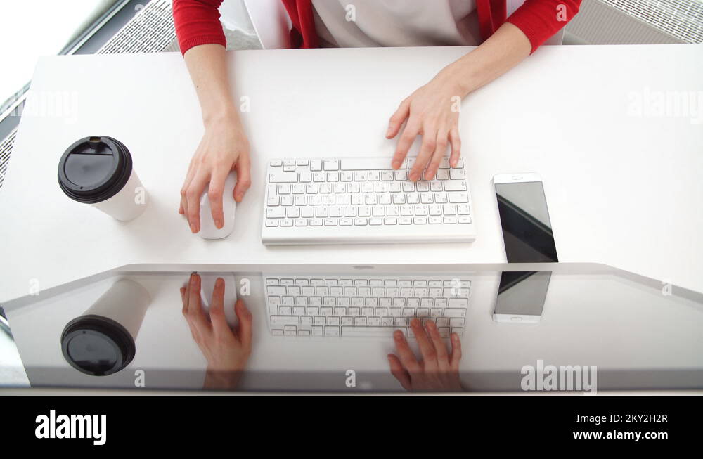 White Office Table and Woman Working on Computer. Top View. Typing on ...
