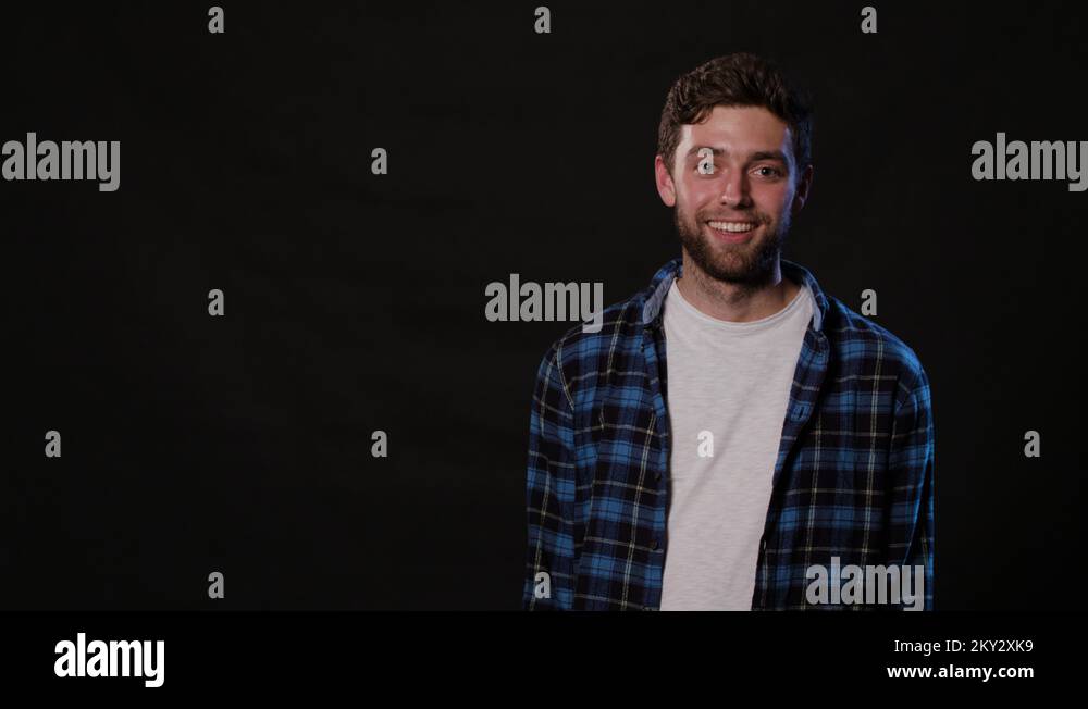 A Young Man Mimicing Against a Black Background Stock Video Footage - Alamy