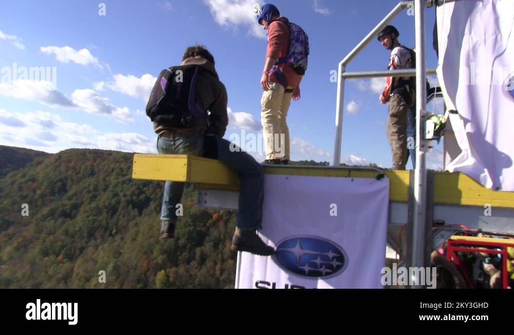 Base jumper jumps from platform and free falls before deploying ...