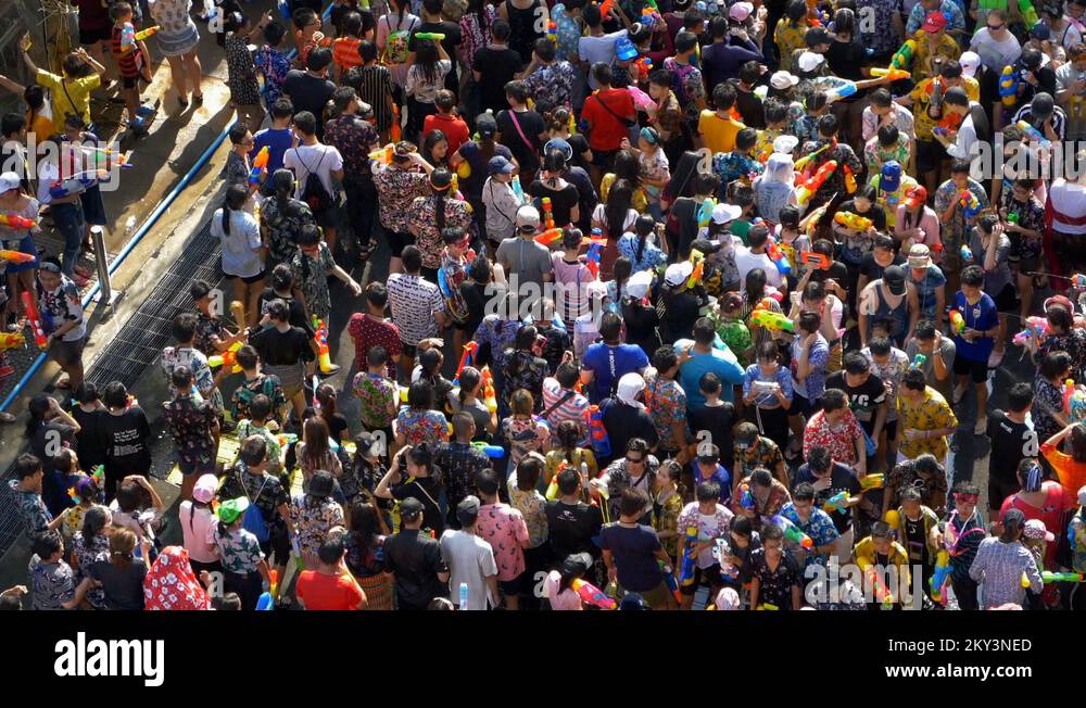 overhead tilt large crowd at songkran waterfight Stock Video Footage ...