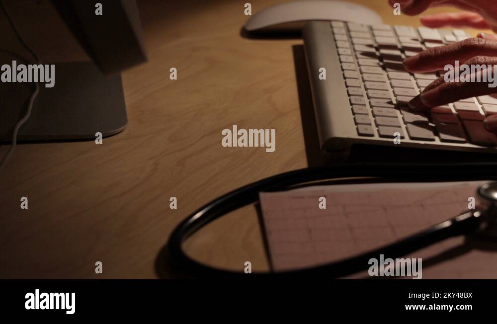 Doctor Typing On A Keyboard With Stethoscope And Graph Chart On A