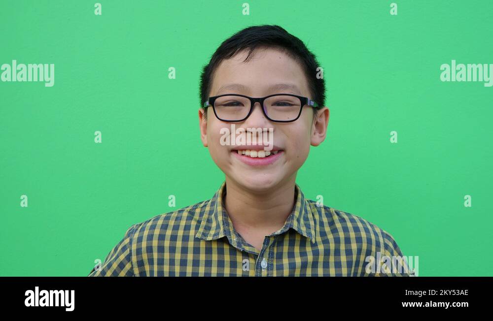Young boy smiling in front of green screen Stock Video Footage - Alamy