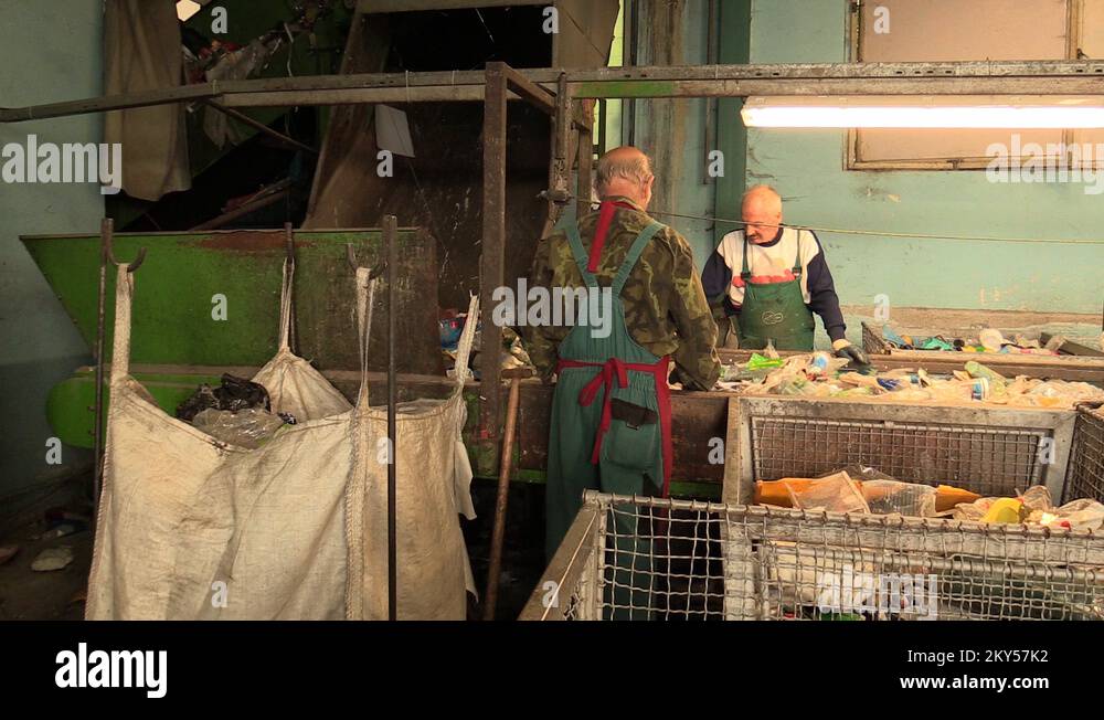 Line industrial sorting of different types of plastics waste people ...