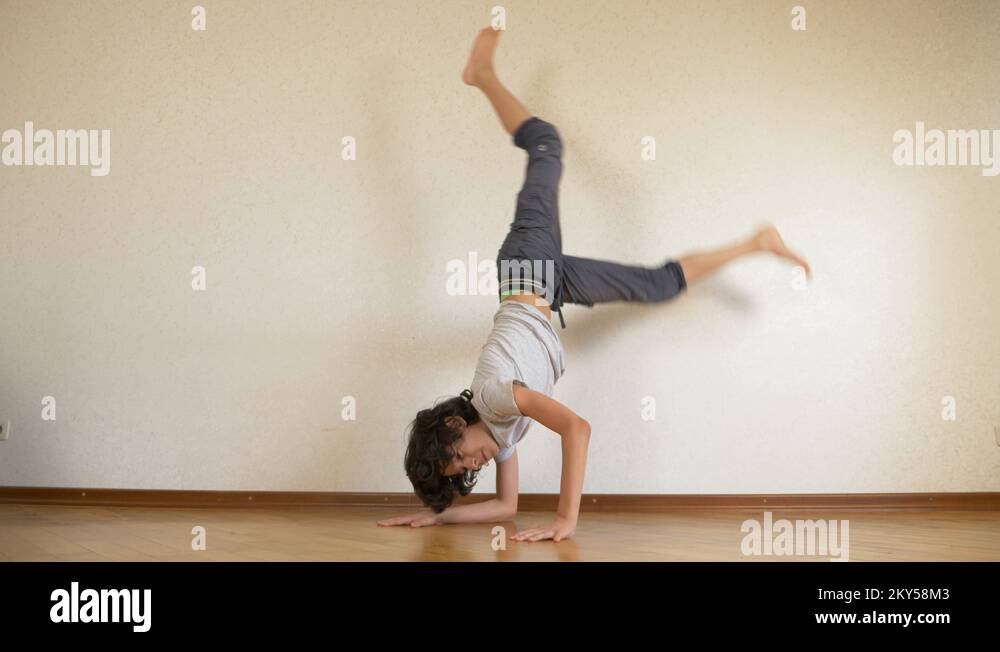 boy teenager, dancer break dance, trains in the dance hall. 4k, slow ...