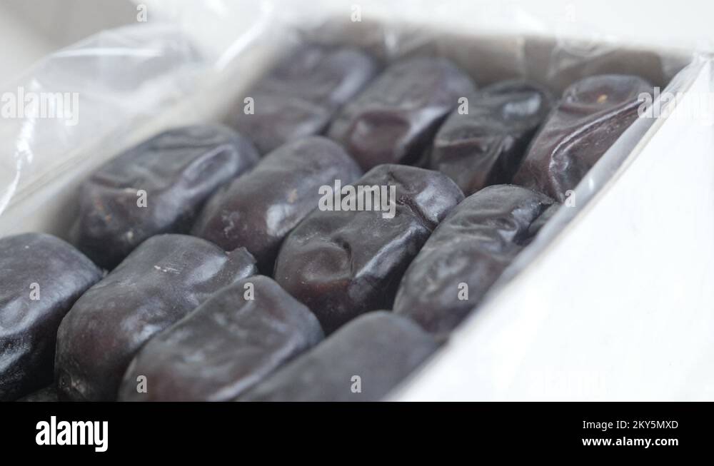 Fresh date palm picking from opened package Stock Video Footage - Alamy