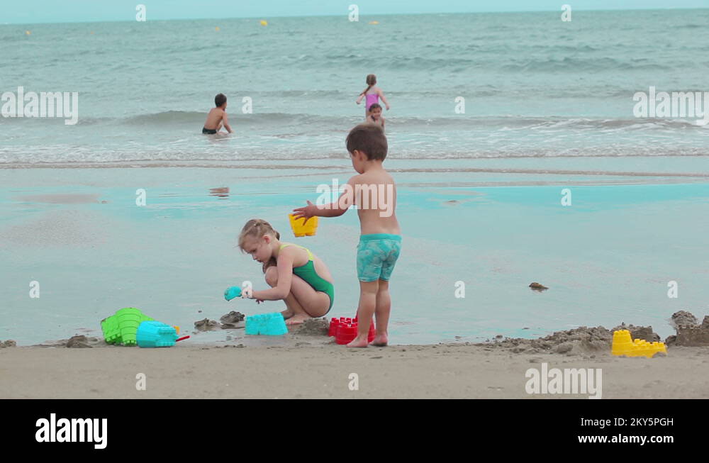 Girl is building a sand castles on the beach Stock Video Footage - Alamy