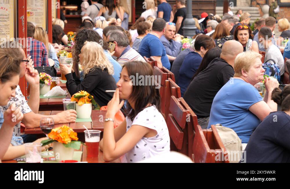 People crowd sit rest in street restaurant tables public place eat ...