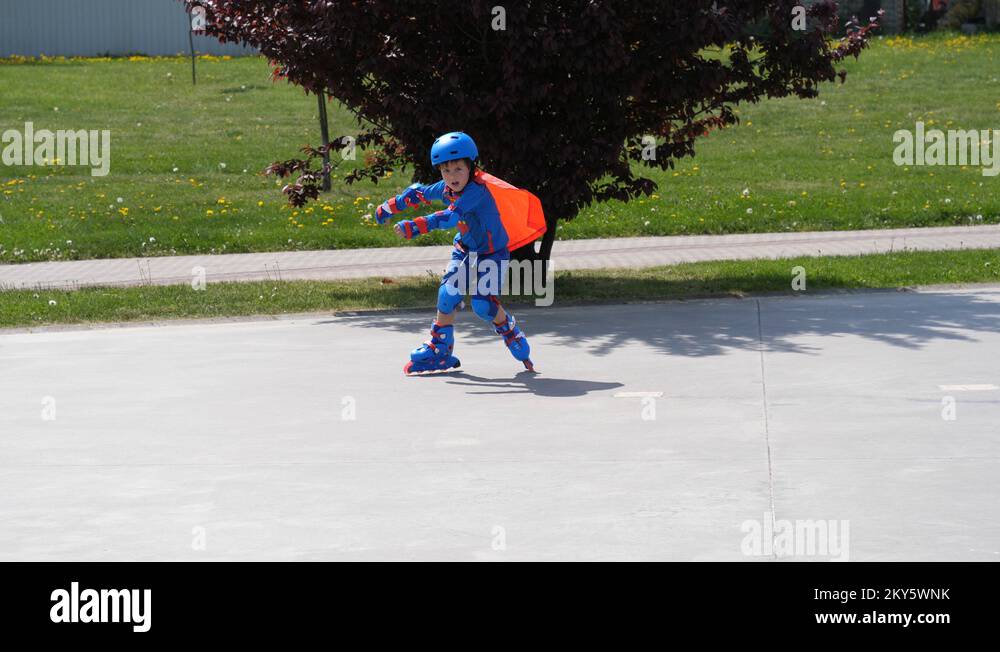 Superman costume kid boy fail falling on rollers riding on a sport ...
