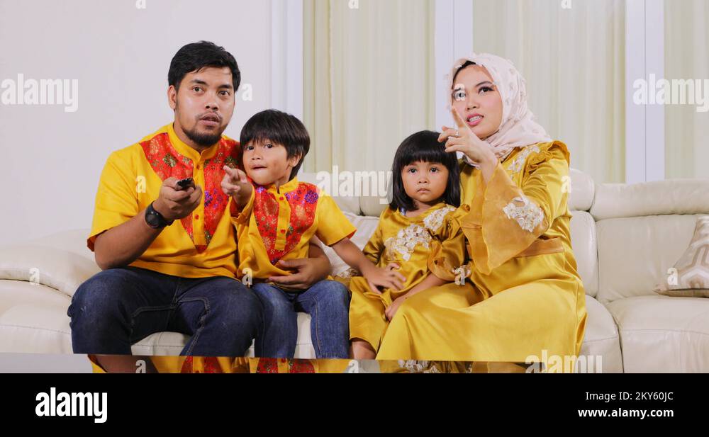 Muslim family watching TV together at home Stock Video Footage - Alamy