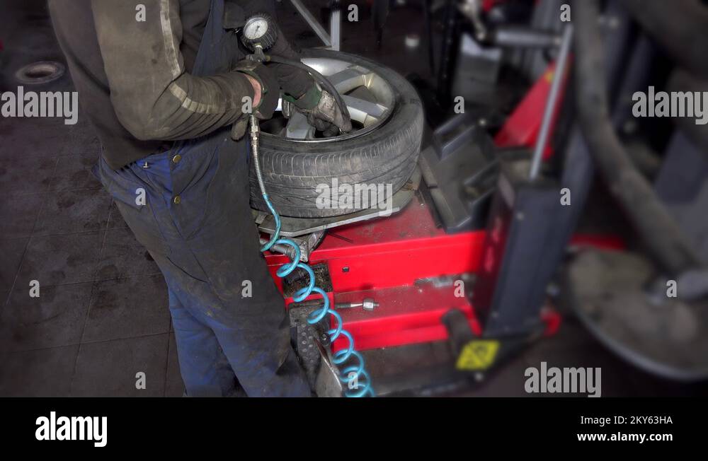 man inflate tire air on mounting machine Stock Video Footage - Alamy