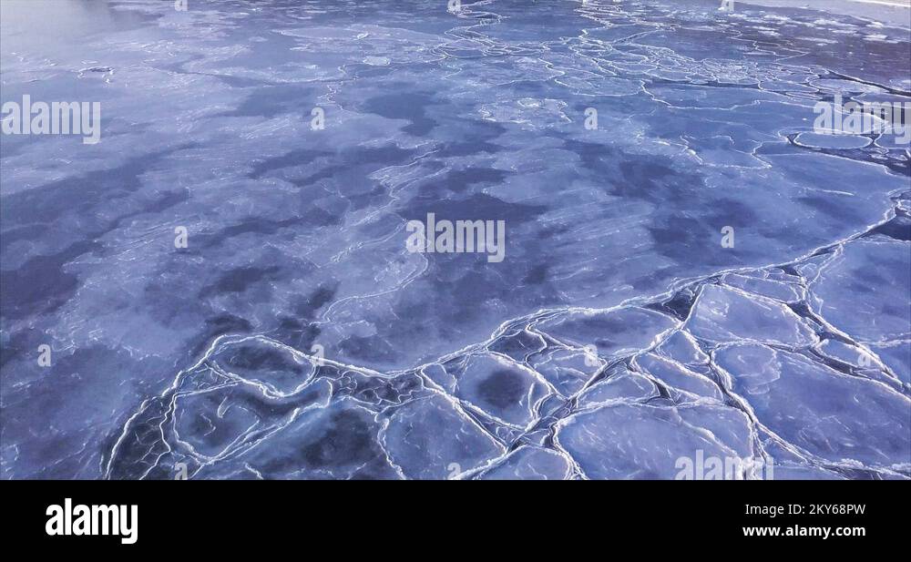 Flying fast above beautiful ice of frozen strait. Aerial top view Stock ...