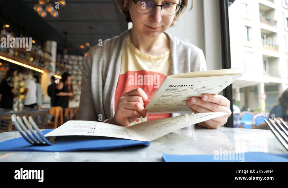 Woman ordering food in restaurant menu reading selecting food Stock ...