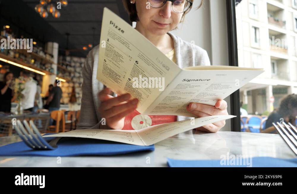 Woman ordering food in restaurant menu reading Stock Video Footage - Alamy