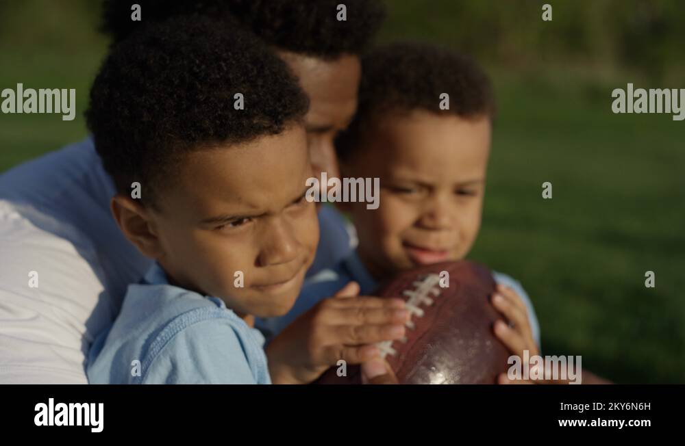 Dad hugging kids playing football Stock Video Footage - Alamy