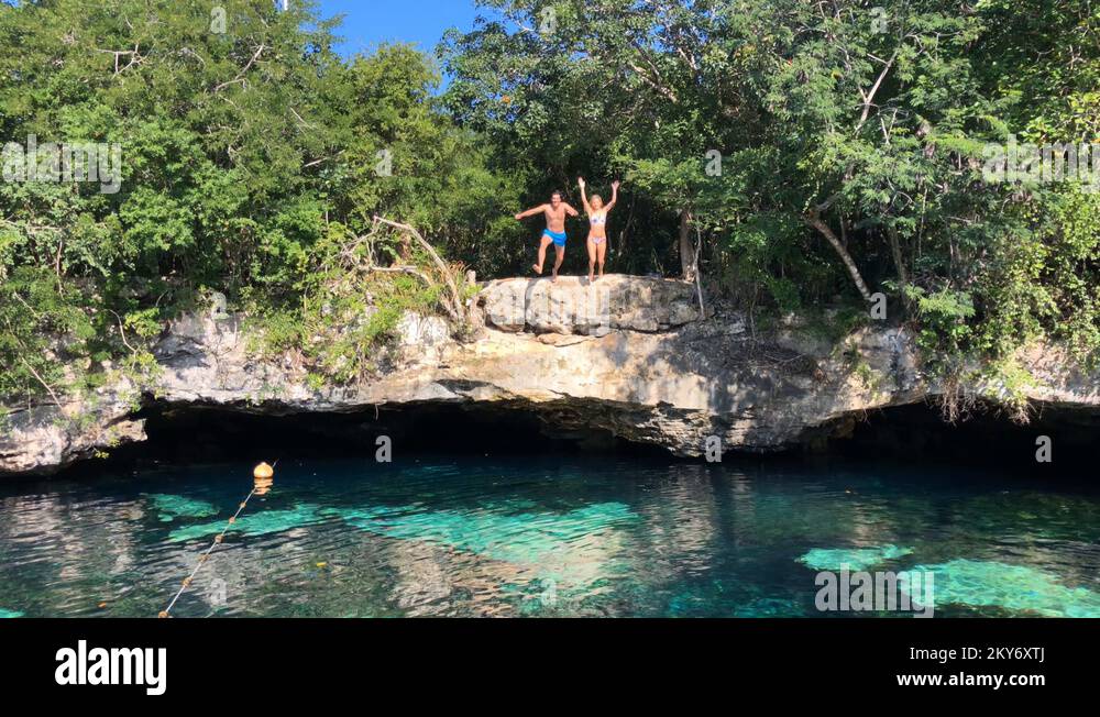 Couple Jumping Into a Cenotes in Tulum Stock Video Footage - Alamy