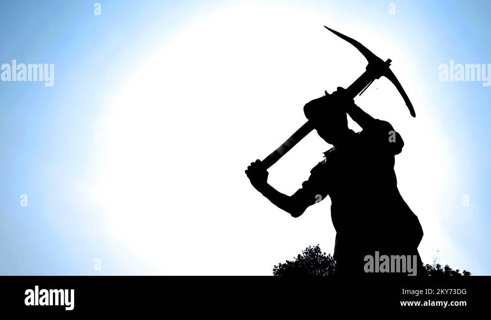 A poor hard working man digging a fertile farmland with Pickaxe or hoe ...