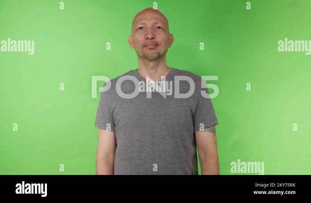 Bald headed Latino man cheering in front of green screen Stock Video ...