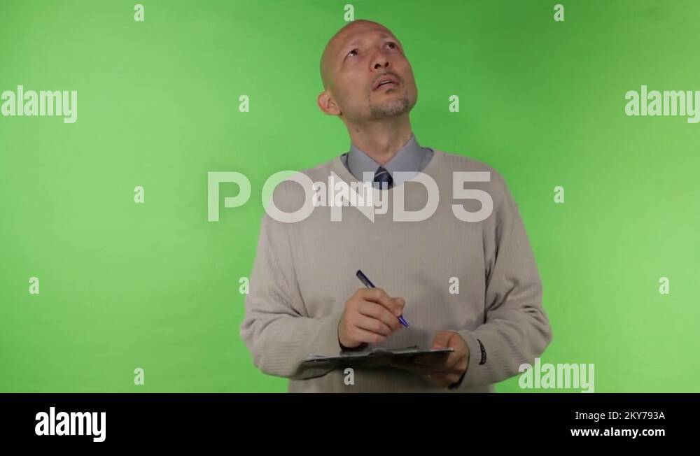 Bald headed man with checklist clipboard in front of green screen Stock ...