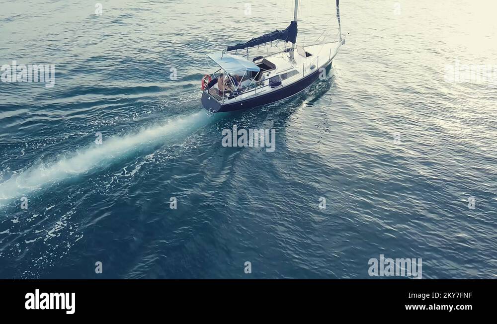 Stunning 4k aerial of sailing boat through blue seas (low angle, crane ...